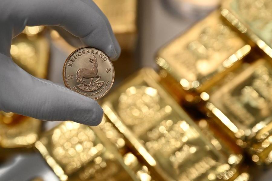 Gold gains on softer dollar, Trump tariff threats
