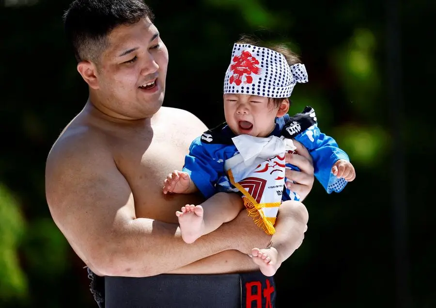 100 crying babies face off at sumo festival