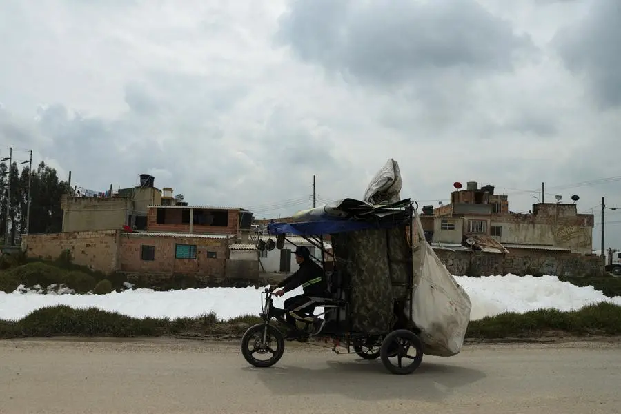 Residents flee foam spewing from polluted river in Colombia