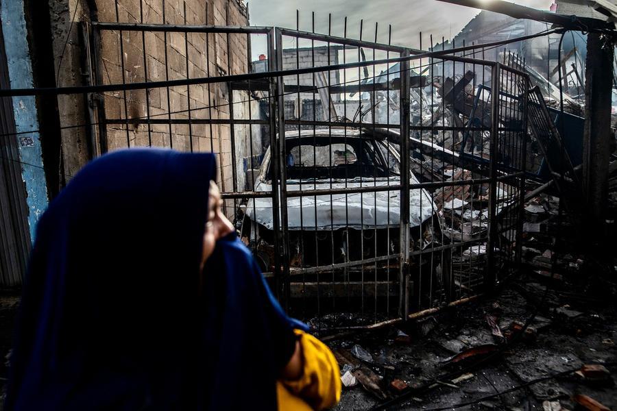 Indonesians search charred homes after fuel depot fire kills 17