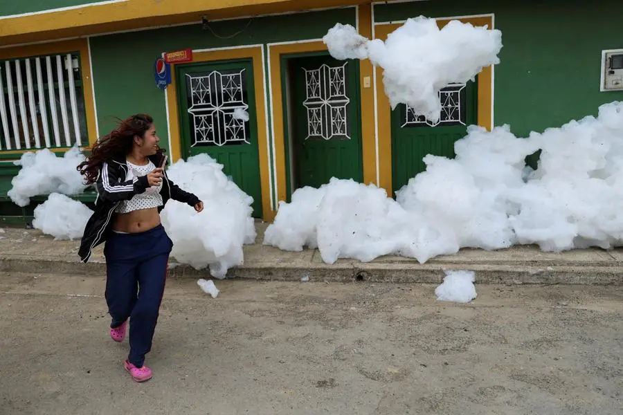 Residents flee foam spewing from polluted river in Colombia